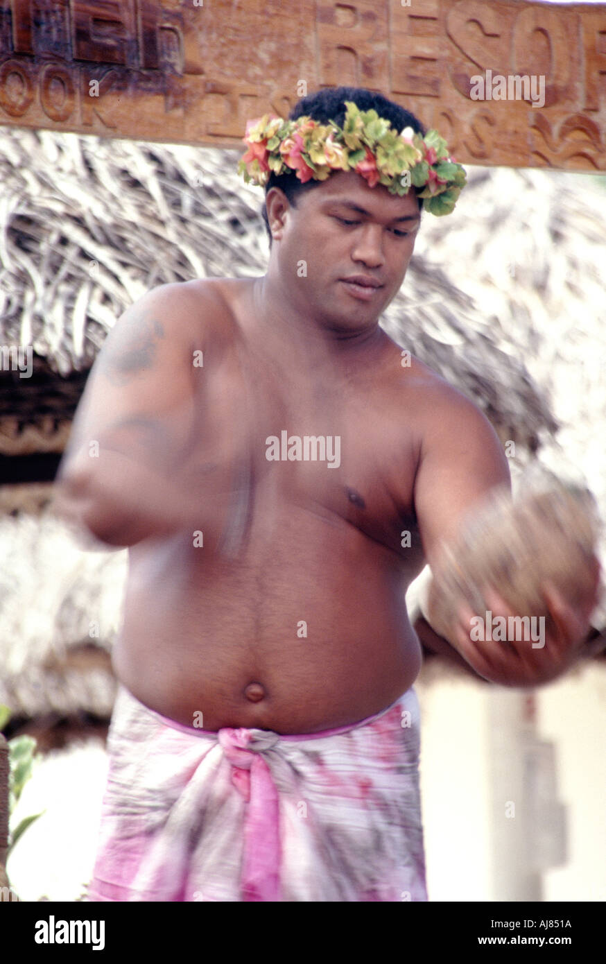 Man demonstrating how to split a coconut Cook Islands Stock Photo - Alamy