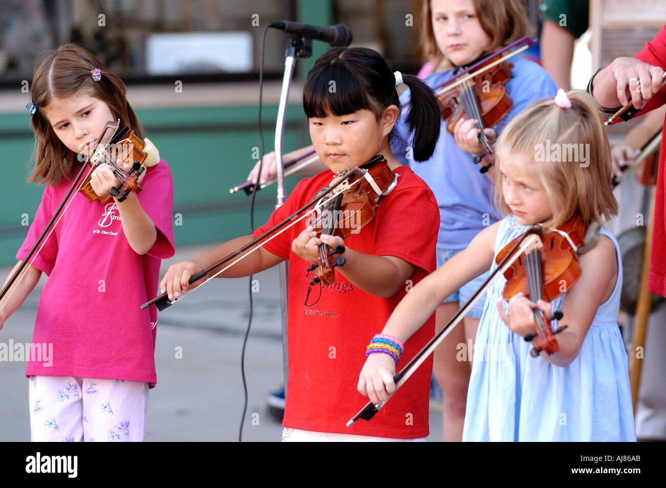 Female Children Playing Violin at Outdoor Recital Stock Photo - Alamy