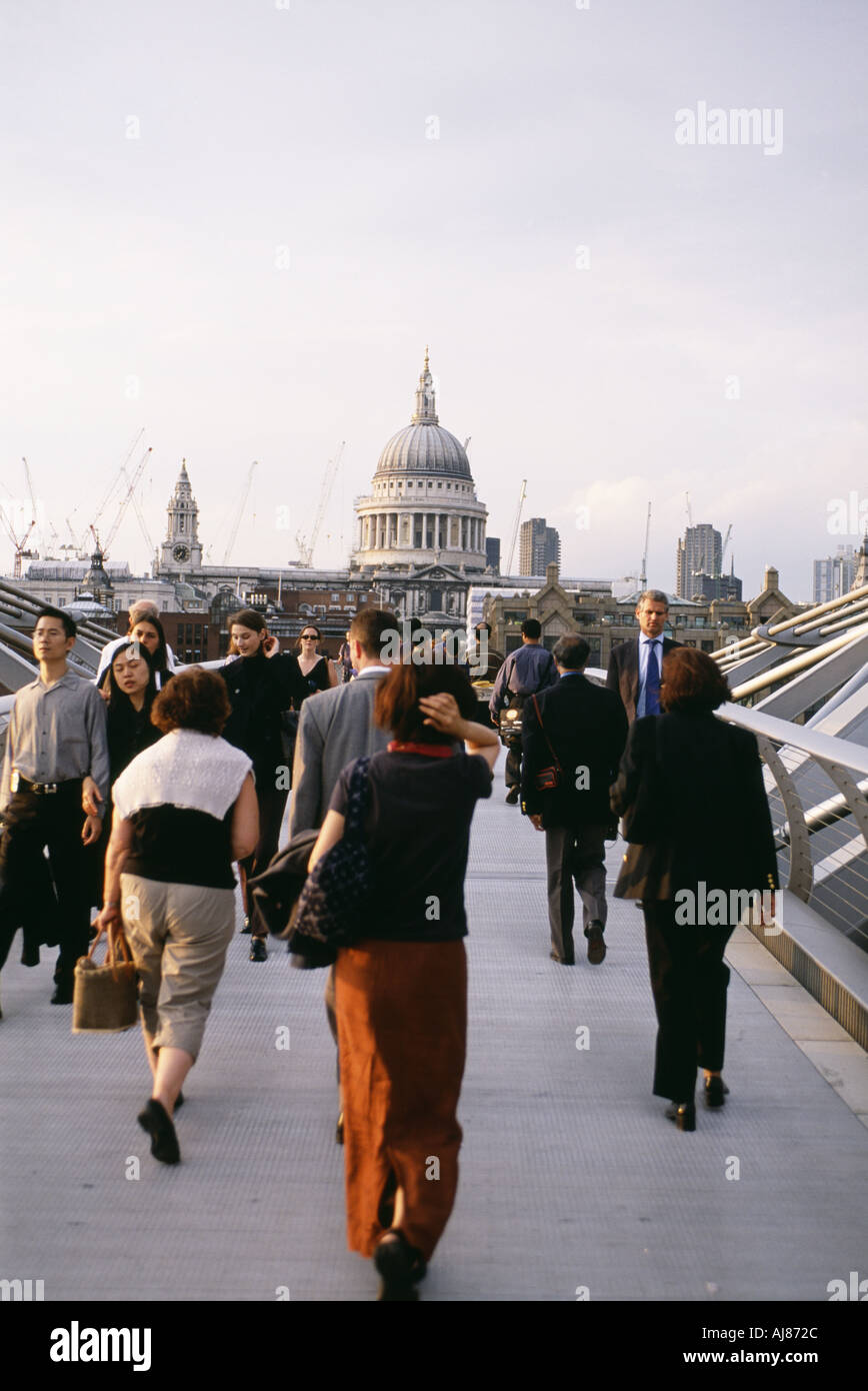 People crossing the Millennium Bridge at dusk designed by Norman Foster ...