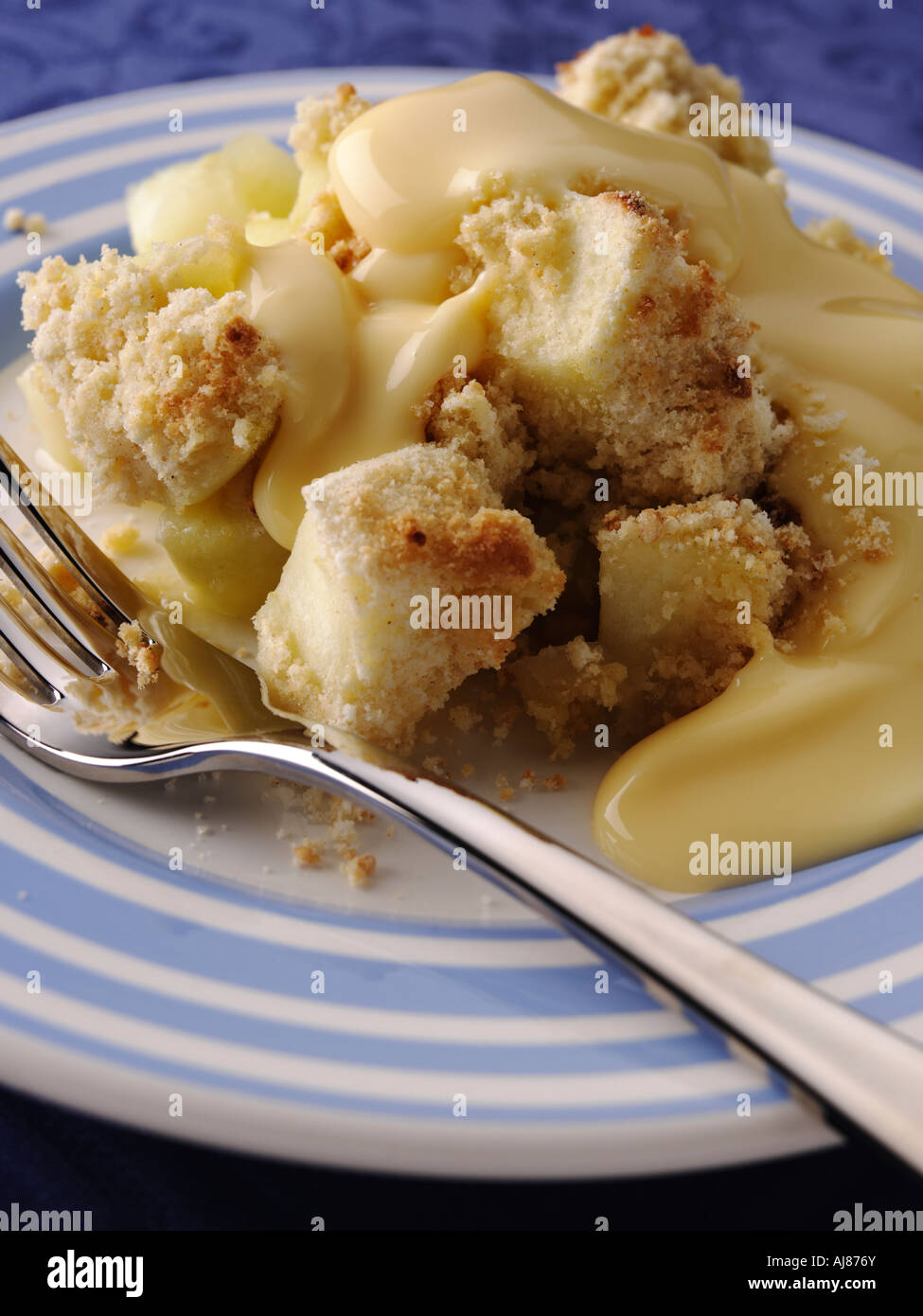 Apple crumble and custard Stock Photo - Alamy