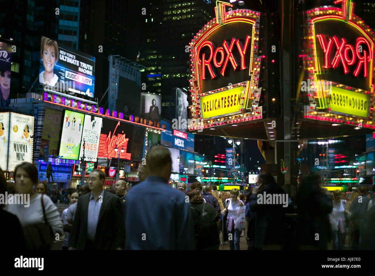 Glass window of Roxy Delicatessin reflects signs and pedestrians of ...