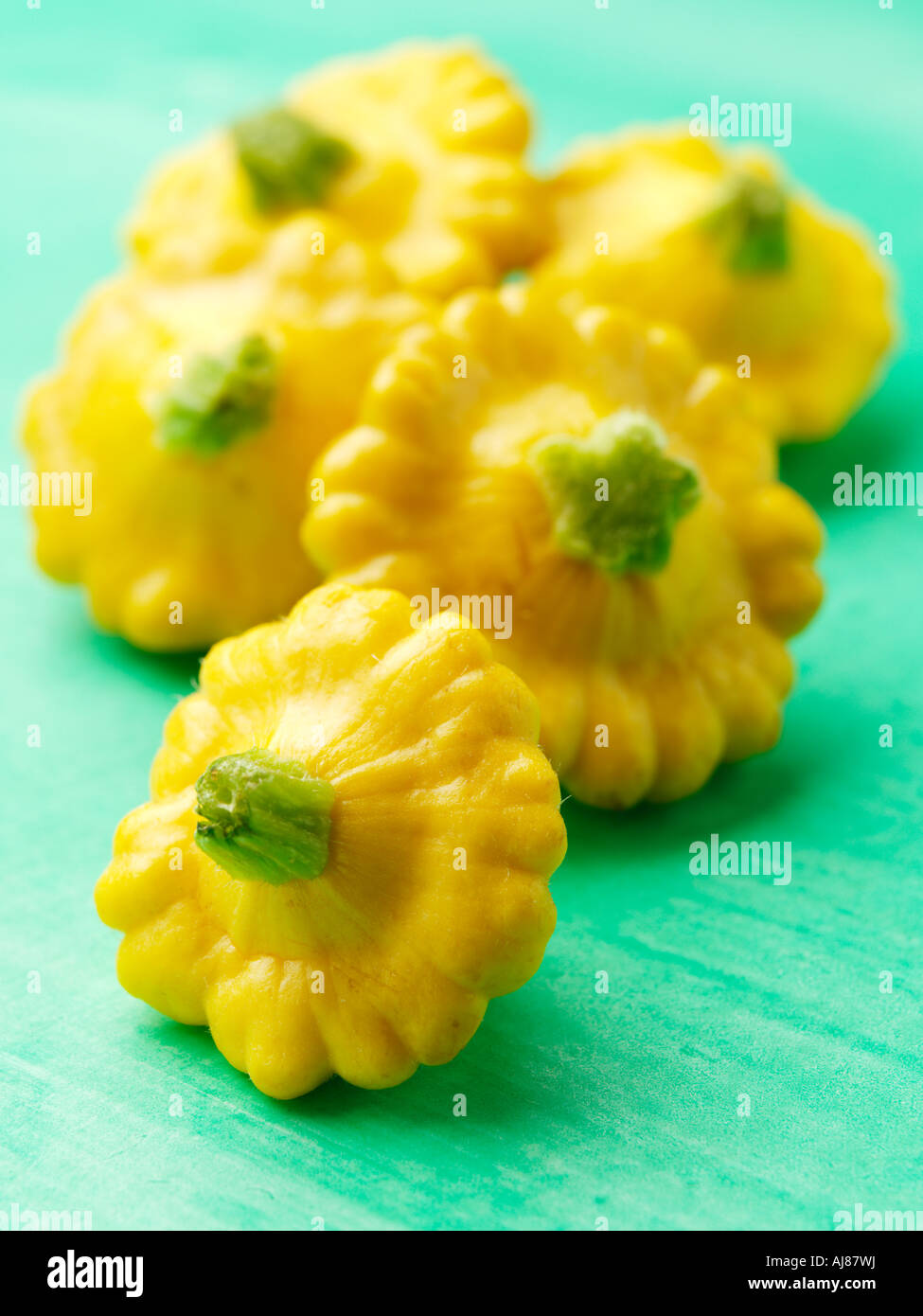 Patty pans on a green background Stock Photo - Alamy