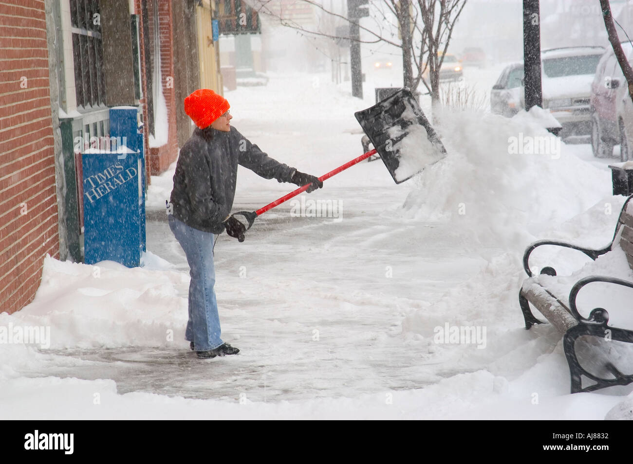 Female Adult Shovels Snow During Storm Stock Photo - Alamy