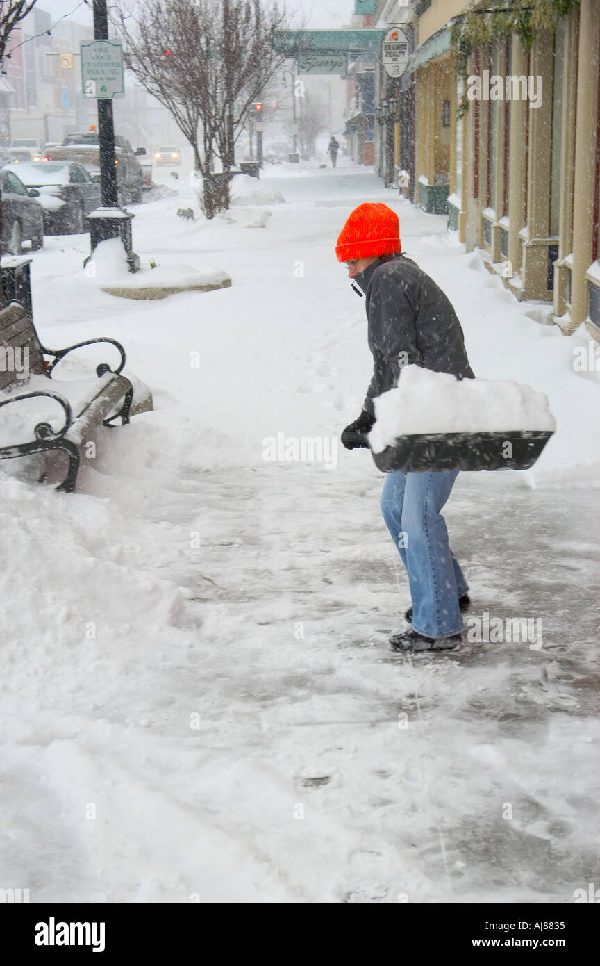 Female Adult Shovels Snow During Storm Stock Photo - Alamy