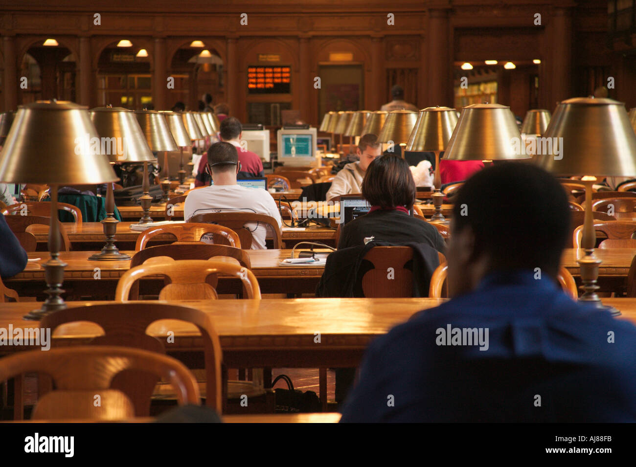 People reading and studying in the main reading room at the New York ...