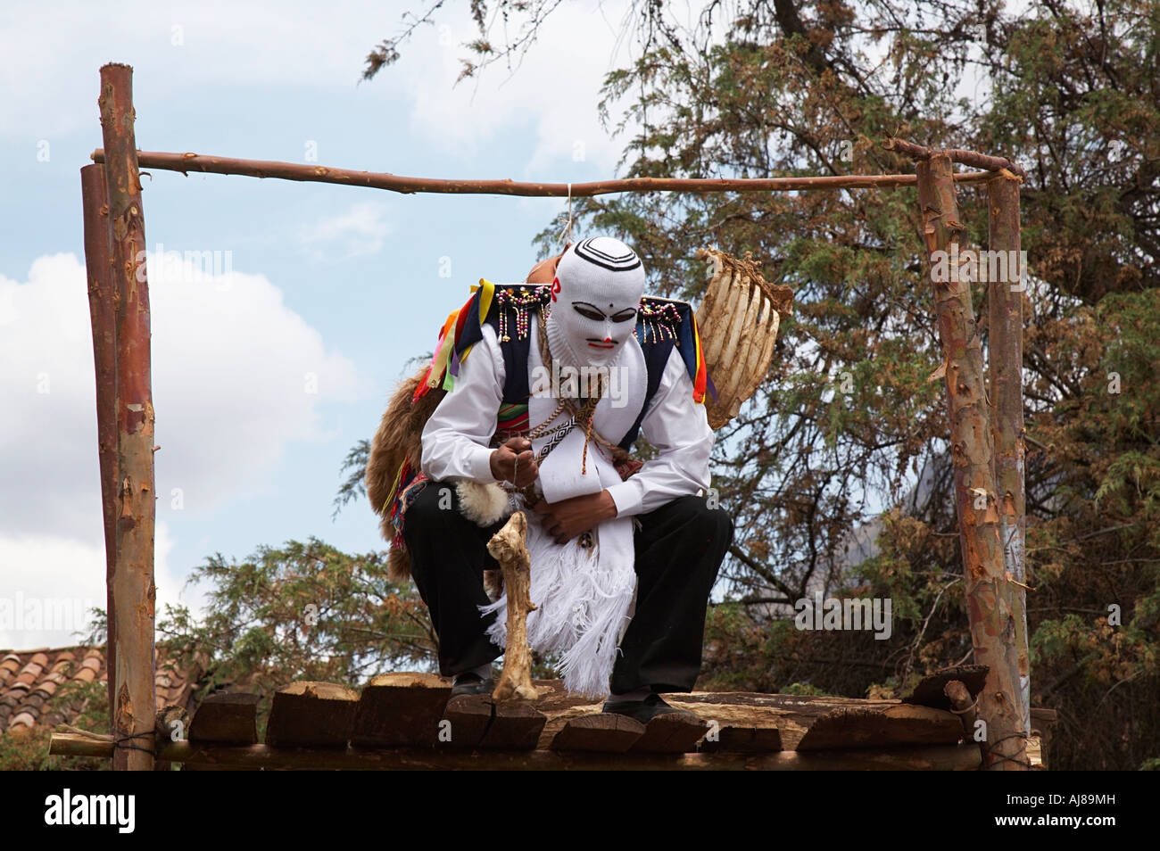 Man dressed as an ukuko a traditional Andean figure crouched on a ...