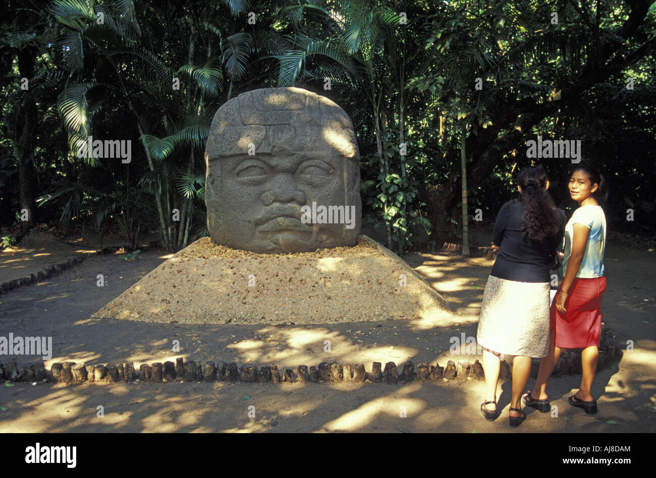 Two women in front of a Colossal Olmec head or Monument 1 at the Parque ...