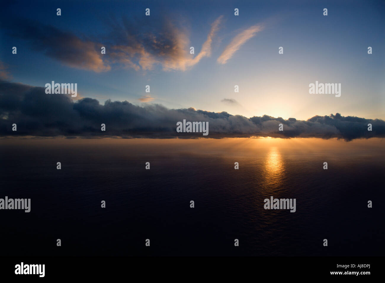 Aerial of sun setting over Pacific ocean with clouds Stock Photo - Alamy