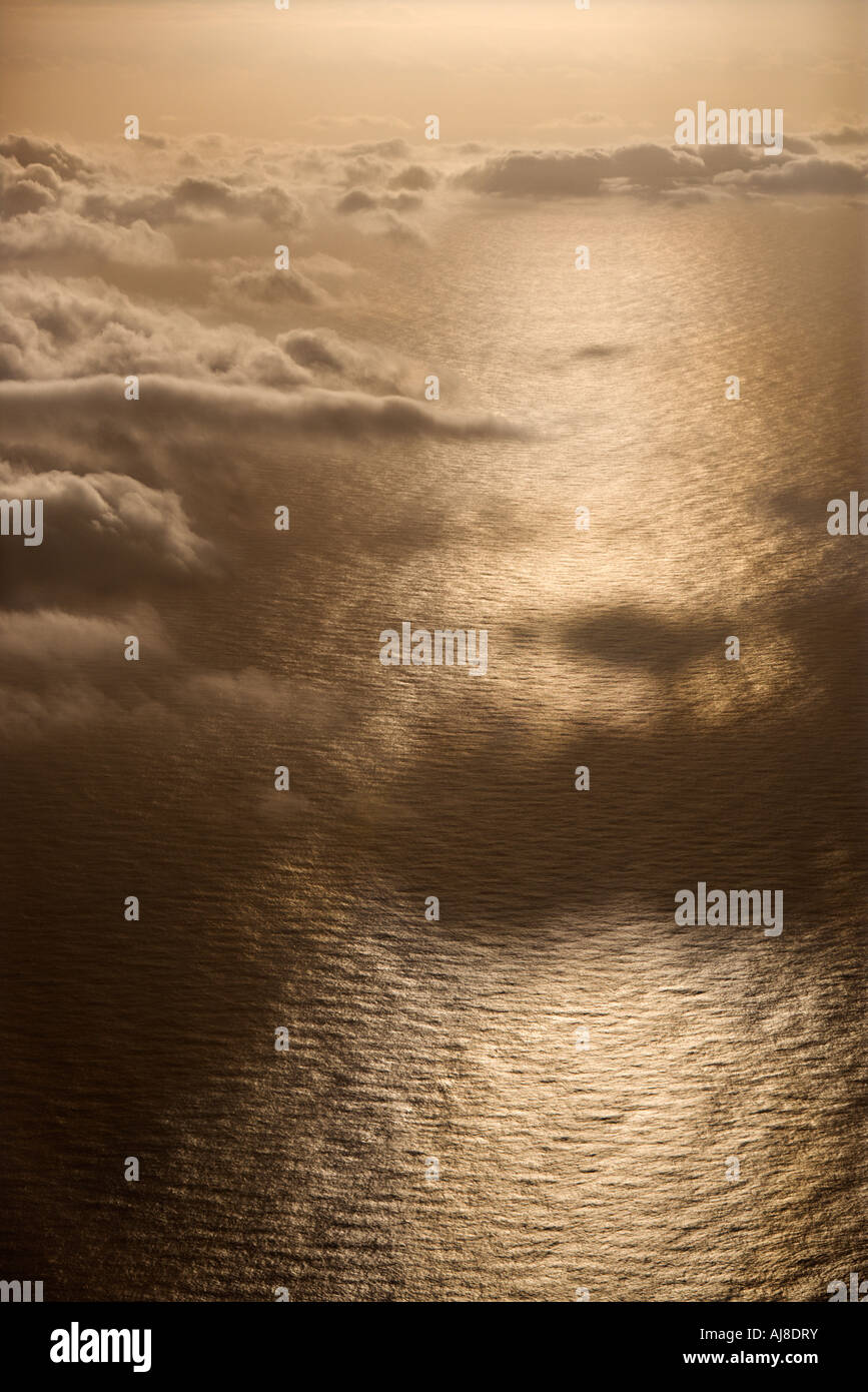 Above clouds view looking down through clouds onto Pacific ocean Stock ...