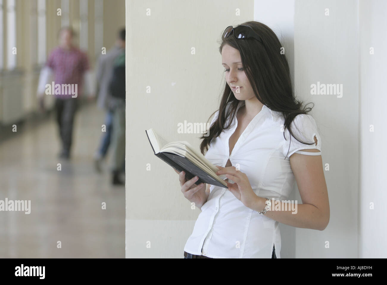 young female student at University reading a book Stock Photo - Alamy