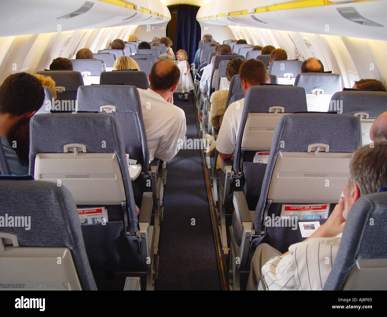 Interior of aircraft with passengers Stock Photo - Alamy