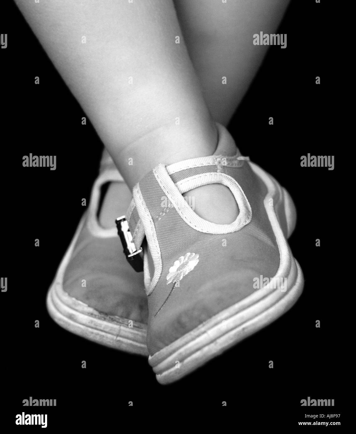 Child s crossed feet Stock Photo - Alamy