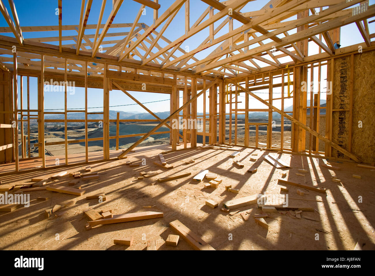 wood frame work of house being built looking from inside to outside ...