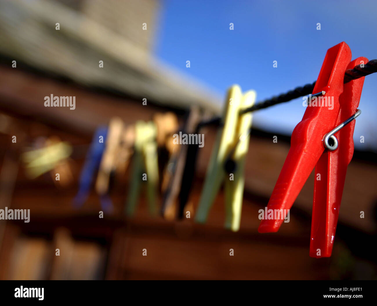 Bright coloured pegs on washing line Stock Photo - Alamy