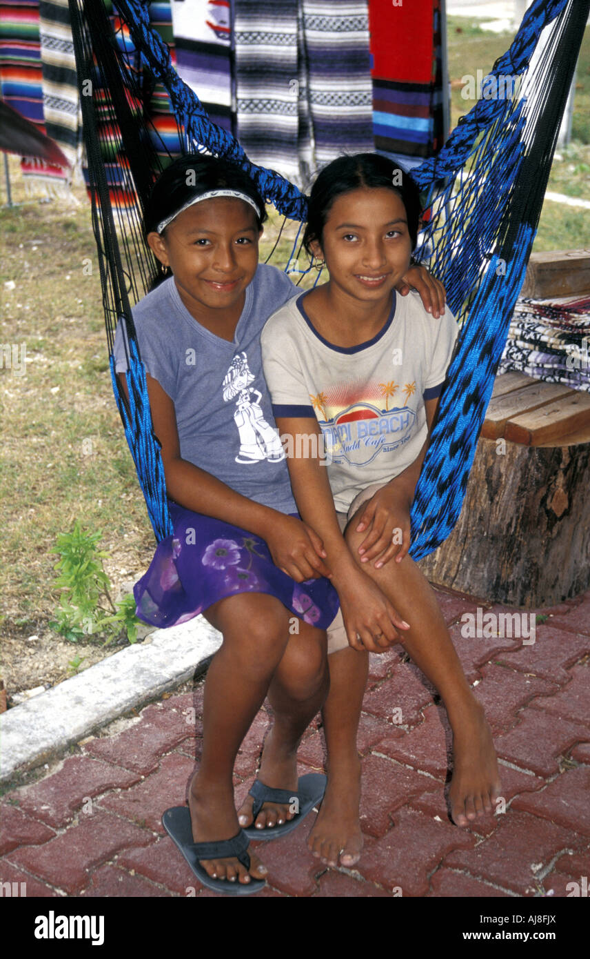 Smiling Mayan girls sisters sitting in a hammock, Quintana Roo, Mexico ...