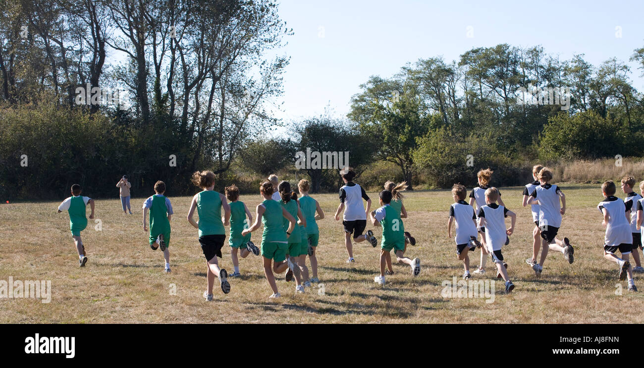 Cross country runners take off in a pack from the starting line This ...