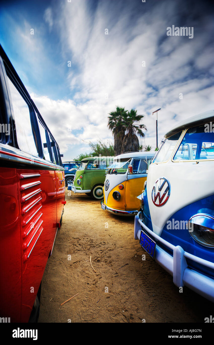 Brightley colored volkswagon vans parked on a beach Stock Photo - Alamy