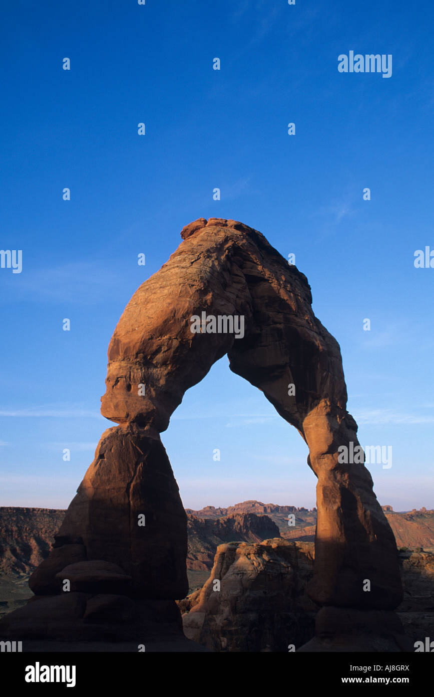 USA Utah Arches National Park Rising sun lights Delicate Arch on winter ...