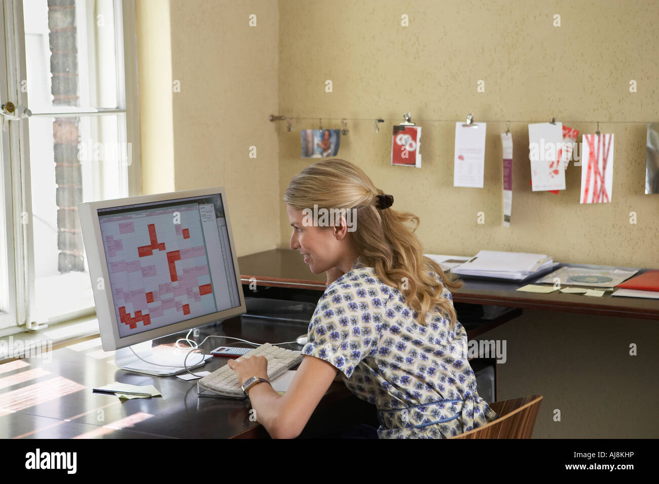 Woman using computer in office Stock Photo - Alamy