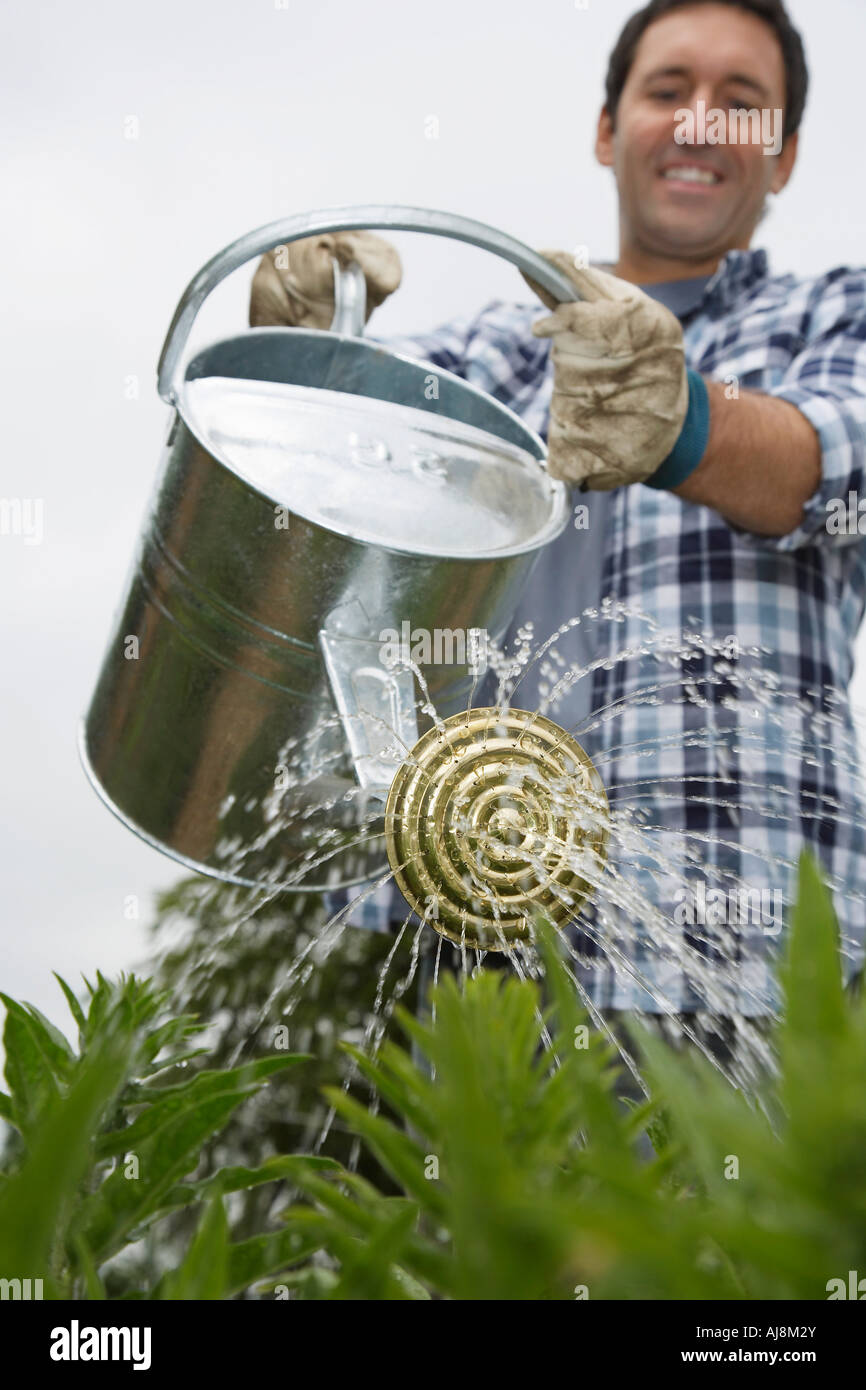 Man watering crops hi-res stock photography and images - Alamy