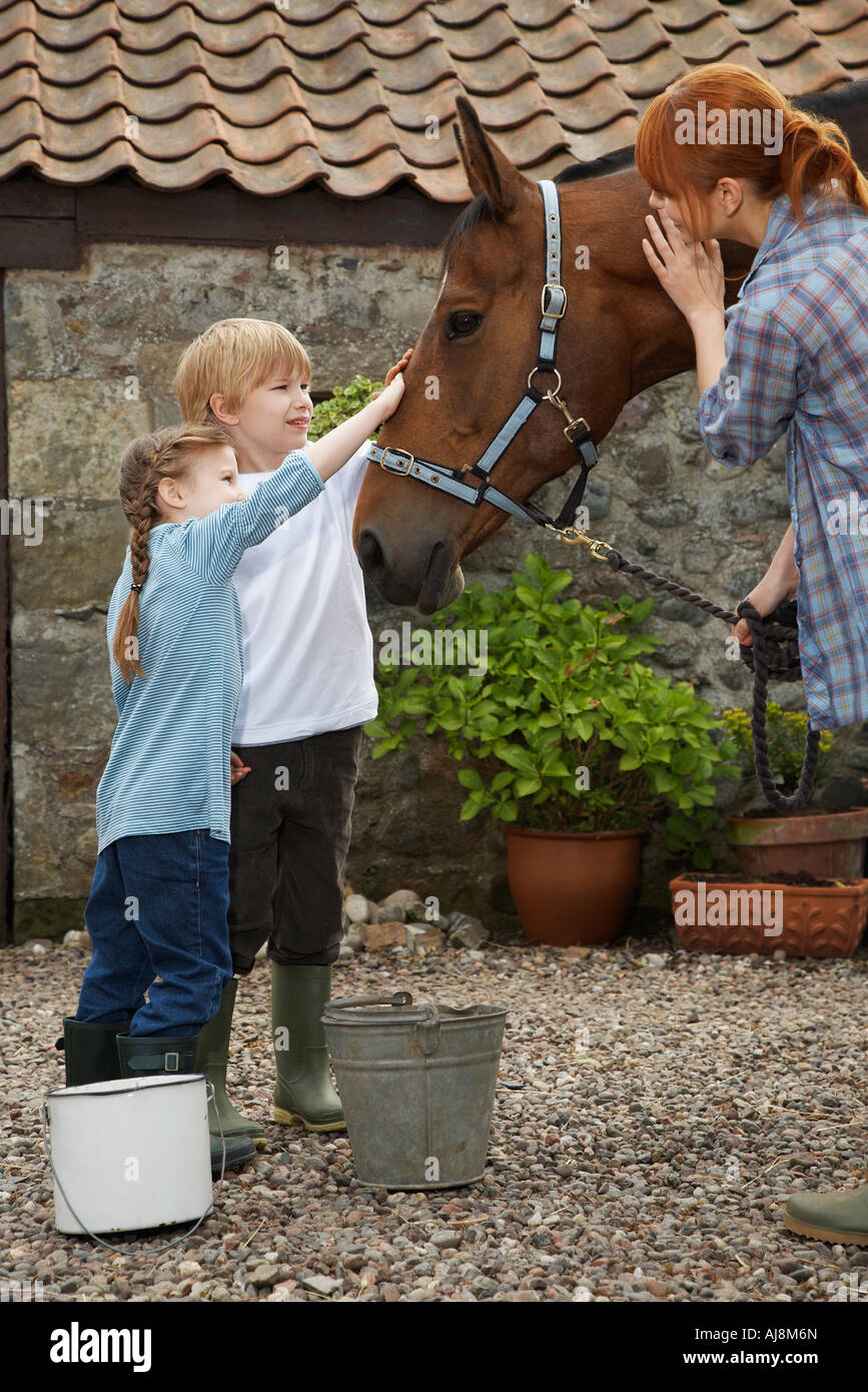 Children stroking horse stable hi-res stock photography and images - Alamy