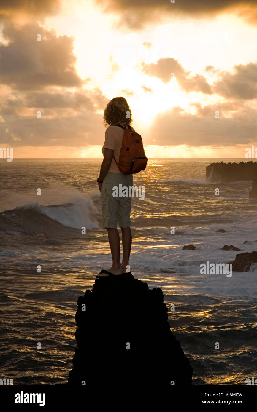 Woman stands on rock above ocean Stock Photo - Alamy