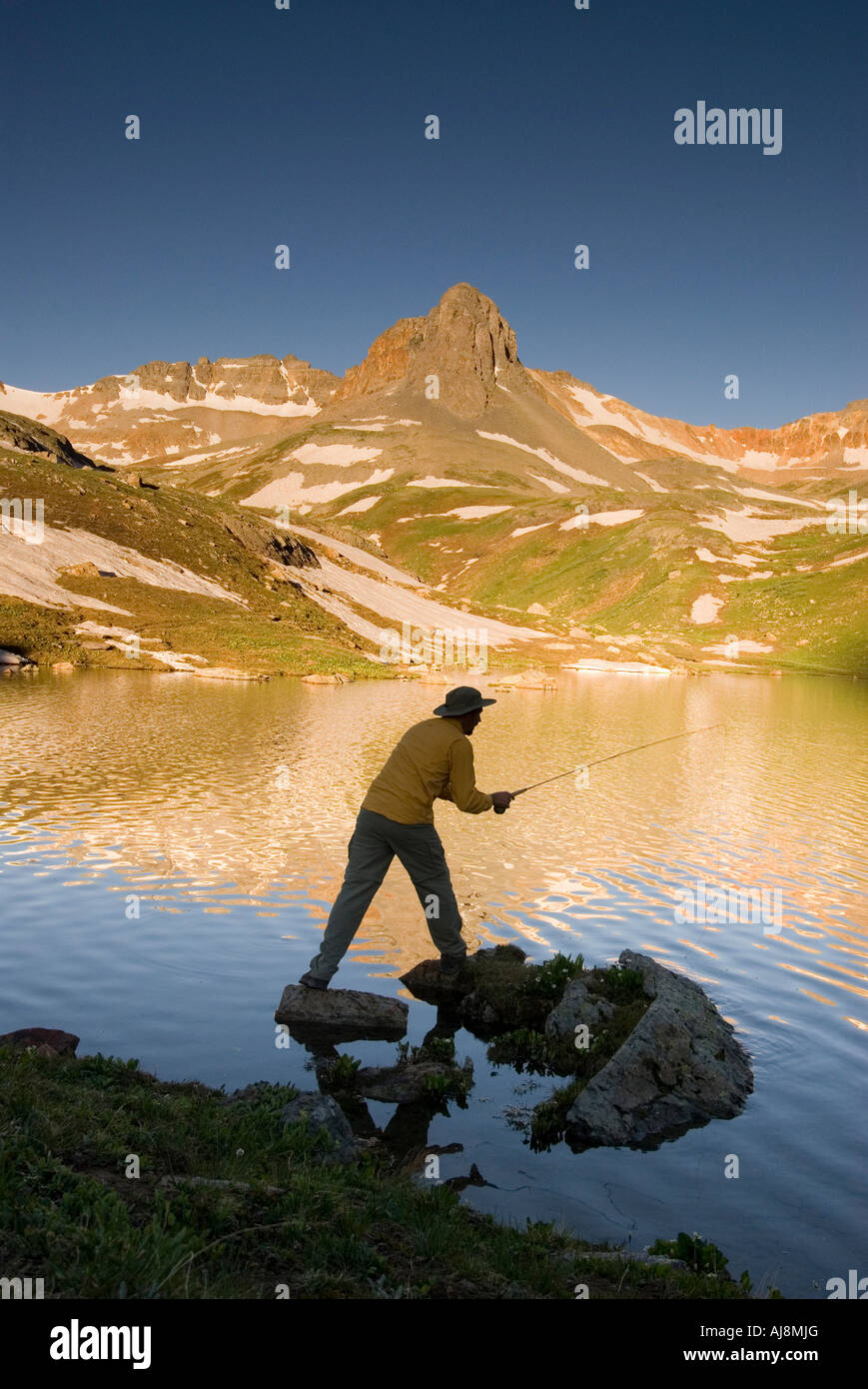 Man fishing in Ice Lake Stock Photo - Alamy