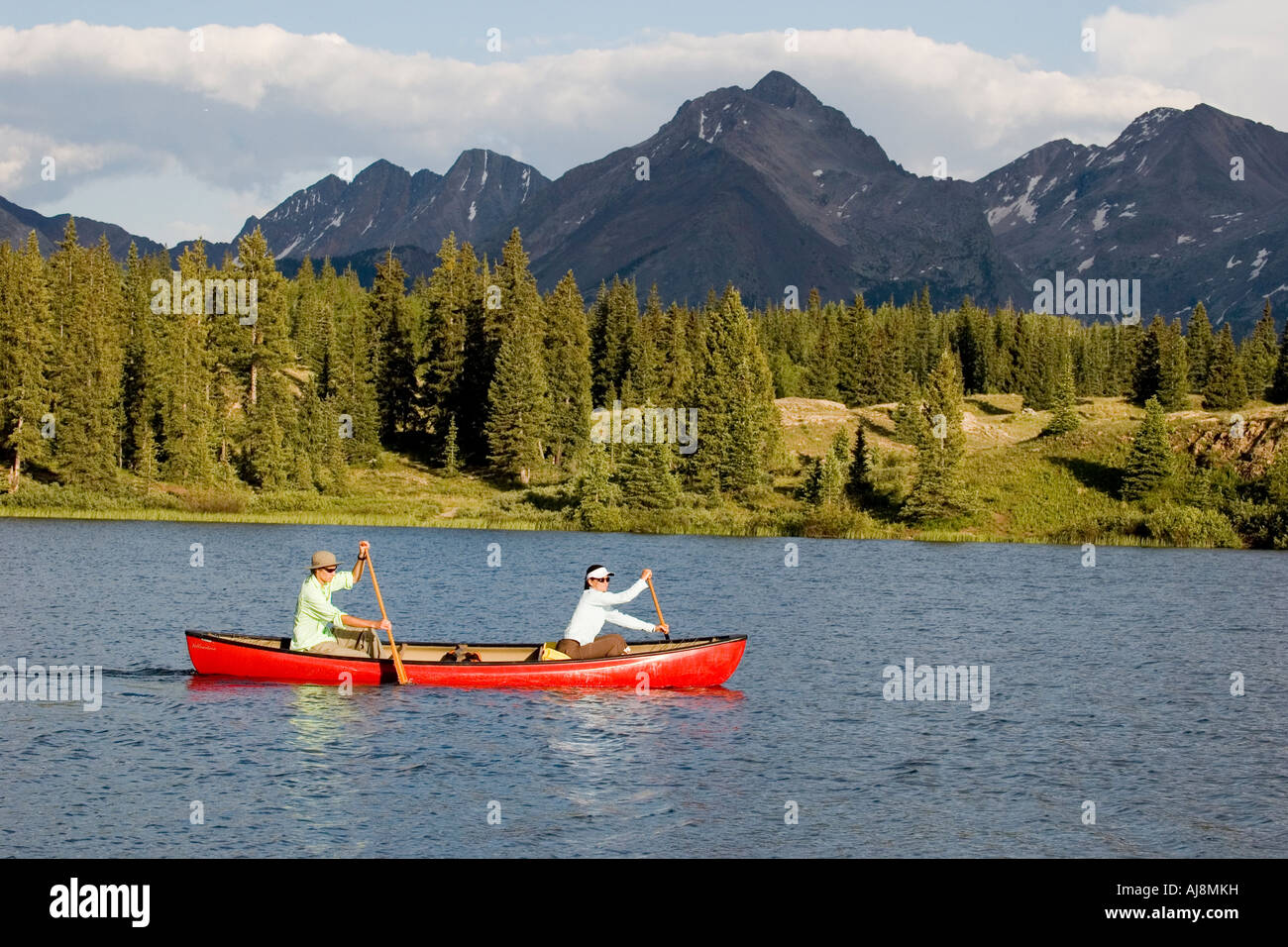 Woman and man in red canoe on lake Stock Photo - Alamy