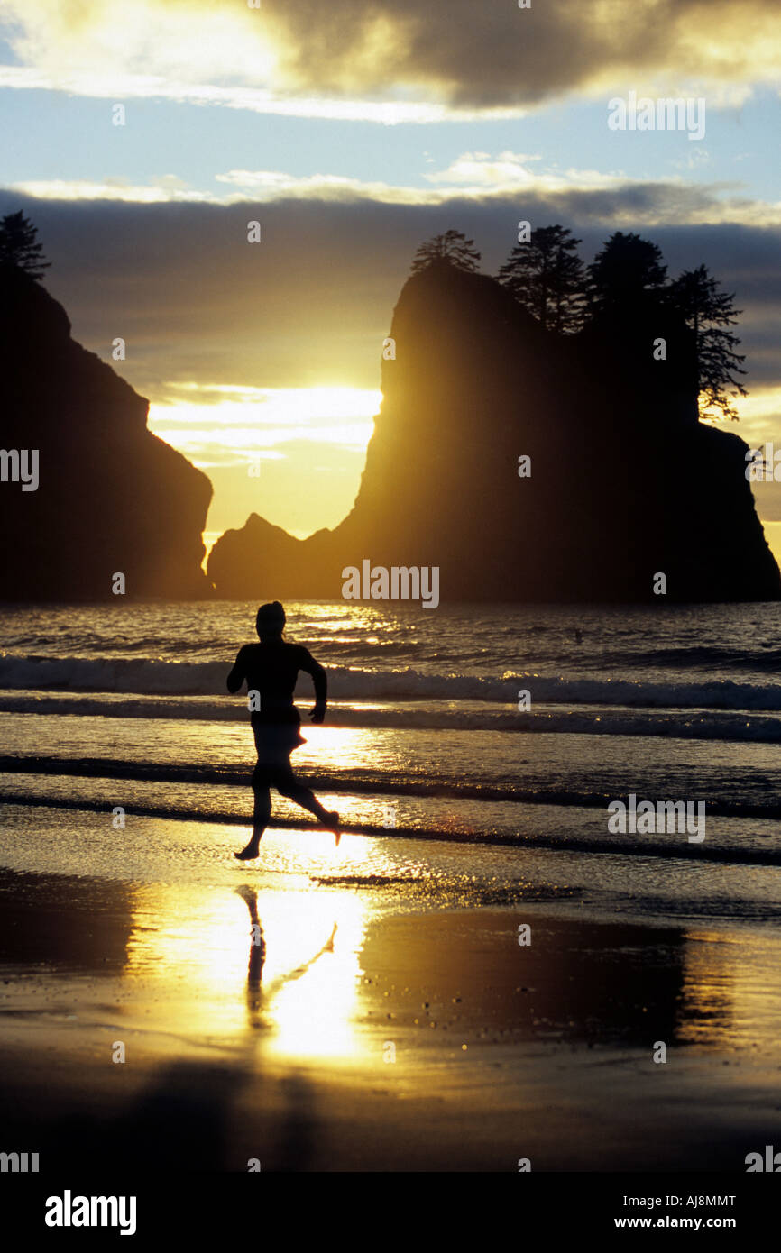Runner at sunset on beach Stock Photo - Alamy