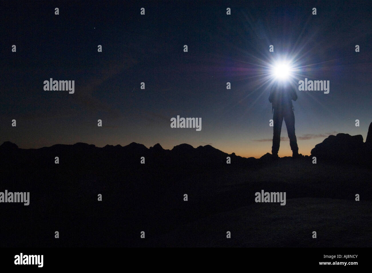 Hiker using headlamp on trail Stock Photo - Alamy