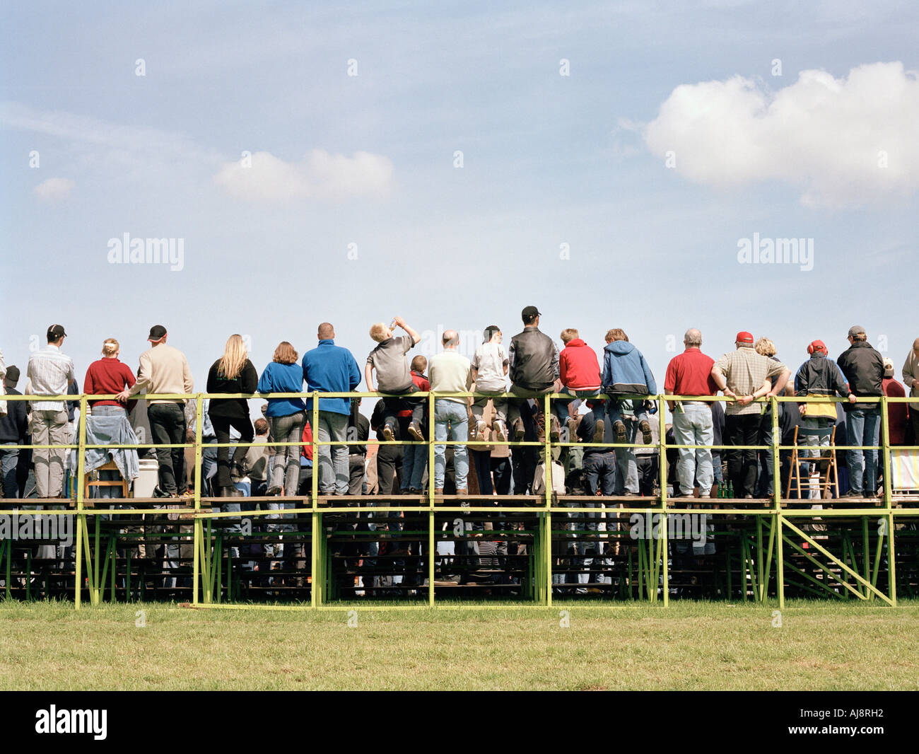 Group of spectators watching from bleachers Stock Photo - Alamy