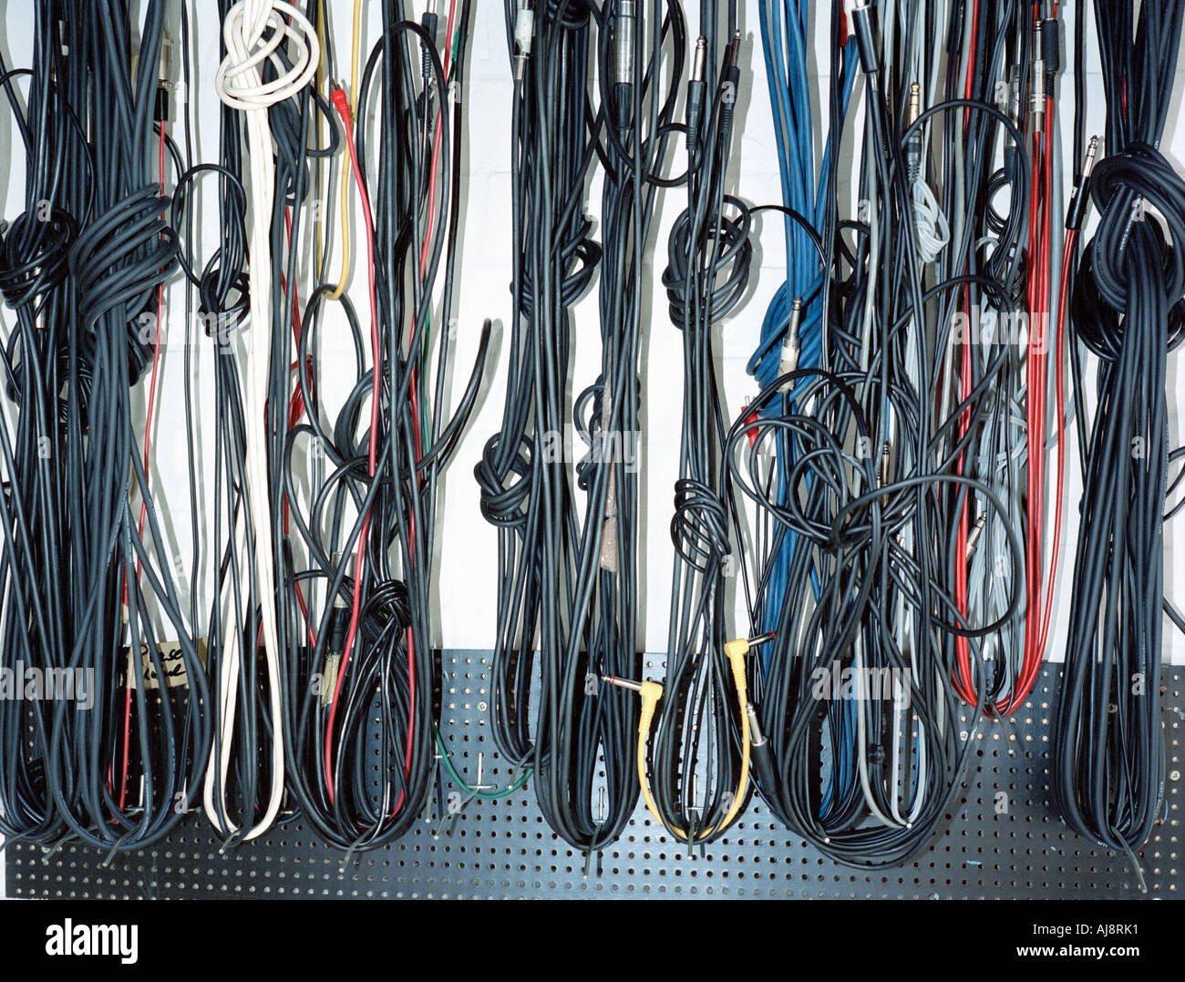 Group of cables hanging on wall Stock Photo - Alamy