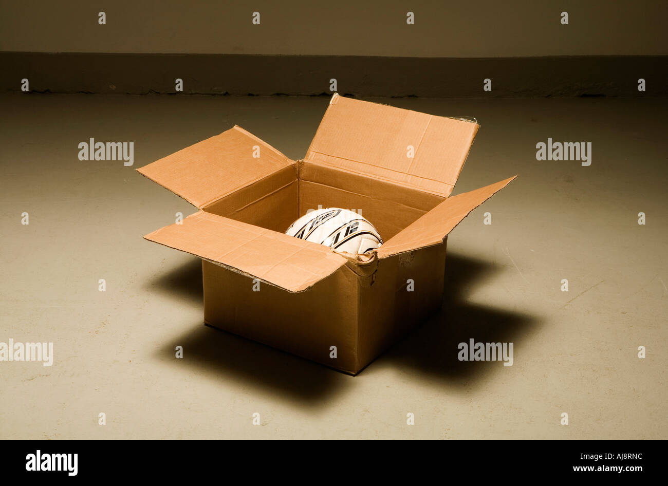 Soccer ball inside of cardboard box Stock Photo - Alamy