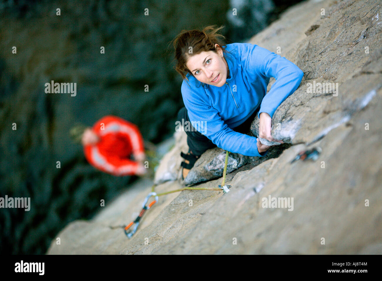 Two people climbing above river Stock Photo - Alamy