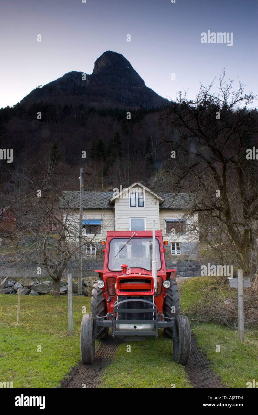 Small house and tractor under high mountains in Buer Vally, Odda ...