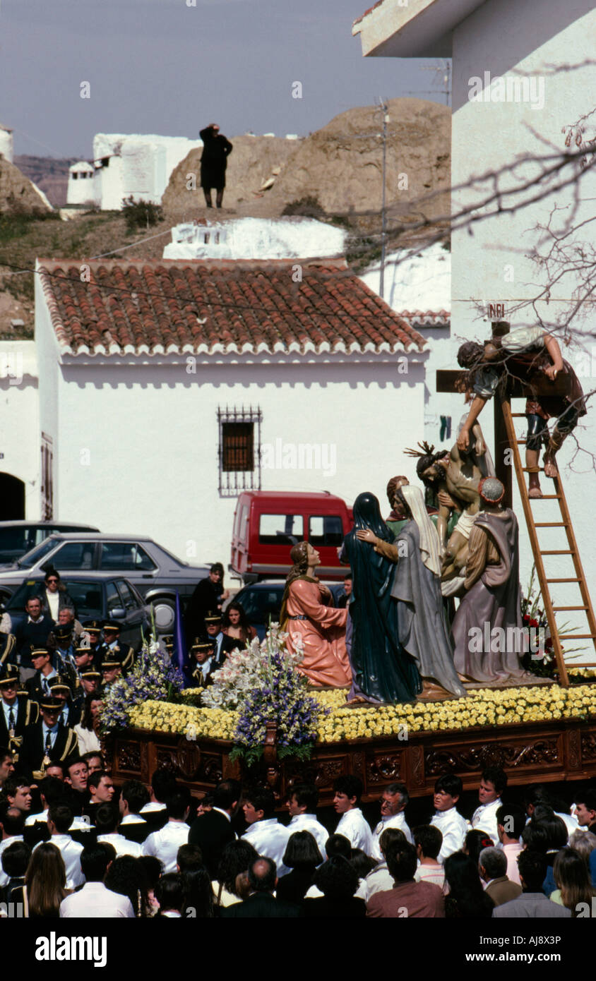 Crowds watch a religious fraternity carrying an effigy of Christ during ...