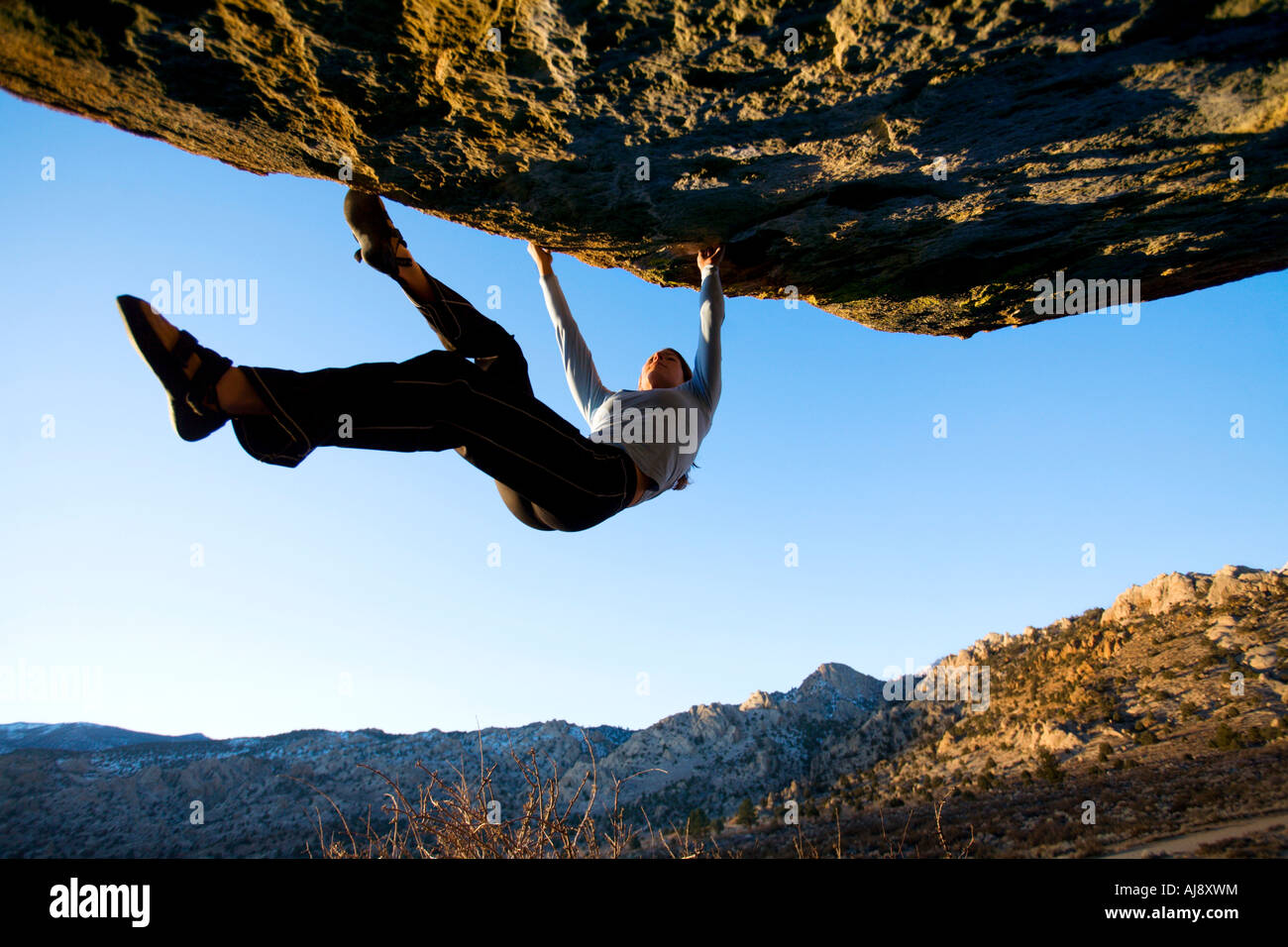 Woman bouldering on an overhang Stock Photo - Alamy
