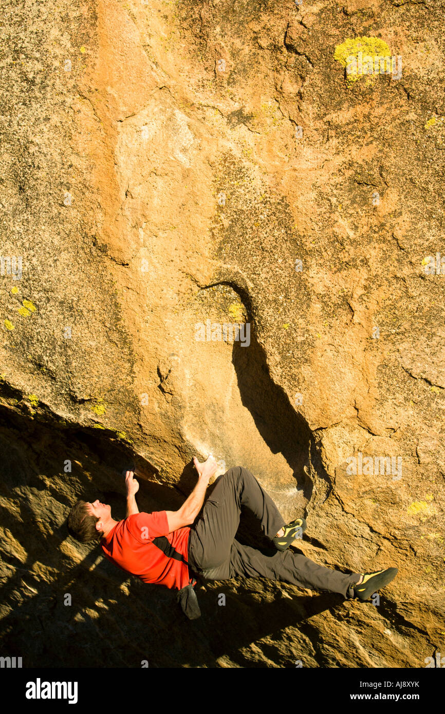 Man bouldering on an overhang Stock Photo - Alamy