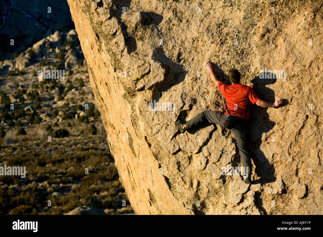 Man bouldering on an overhang Stock Photo - Alamy