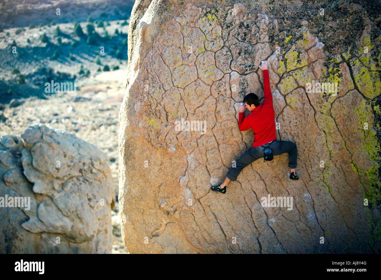 Man bouldering on an overhang Stock Photo - Alamy