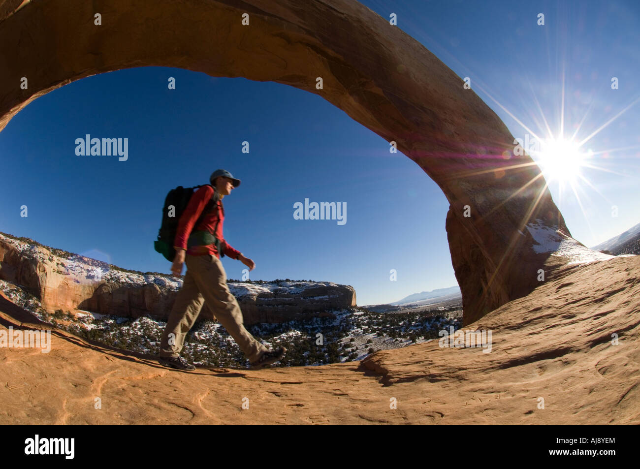 Hiking under arch in Moab Stock Photo - Alamy