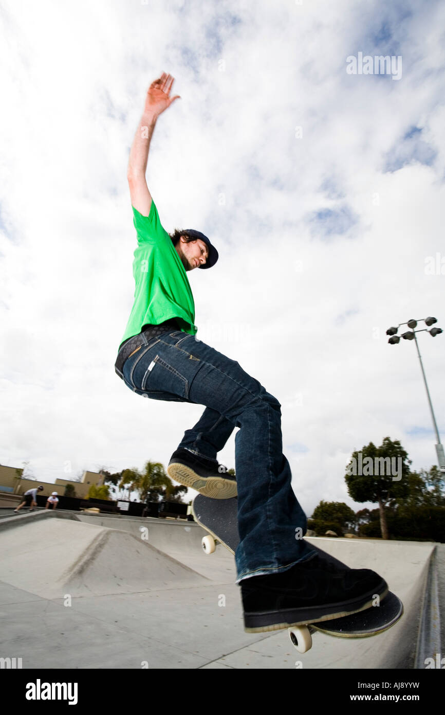 A skateboarder does a trick in mid air Stock Photo - Alamy