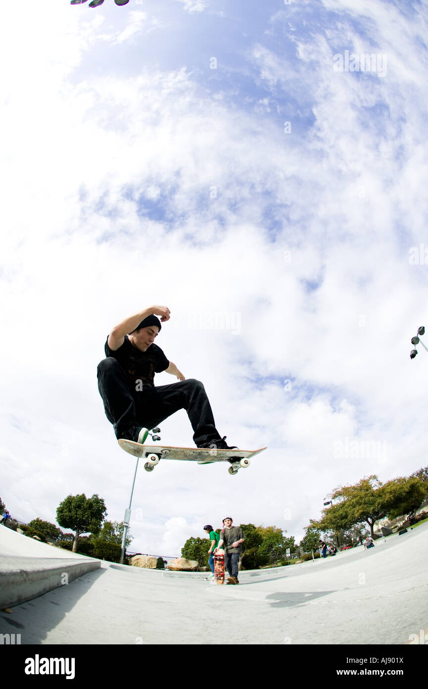 A skateboarder does a trick at the skatepark Stock Photo - Alamy