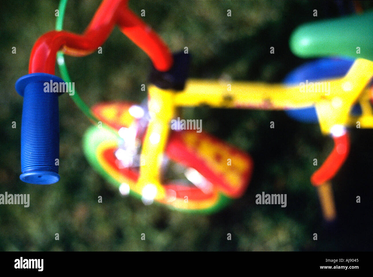 Blue tricycle handlebar Yellow tricycle on lawn in the sunshine Stock ...