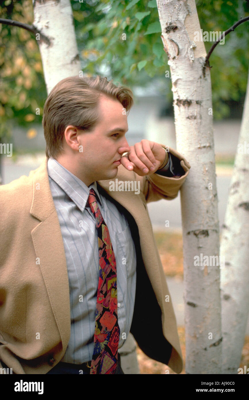 22 year old man by birch trees in front of his house thinking about ...