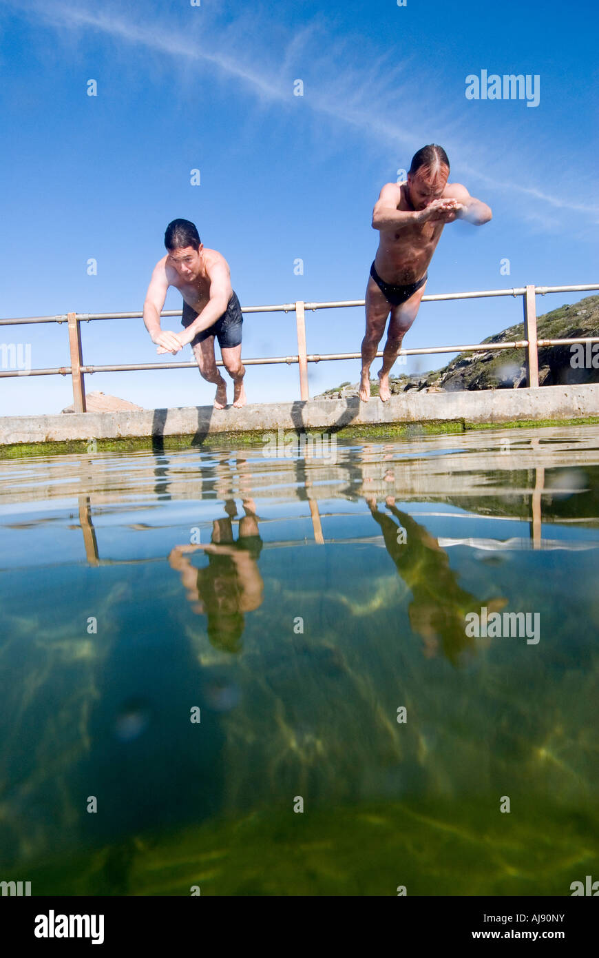 Two men jumping swimming pool hi-res stock photography and images - Alamy