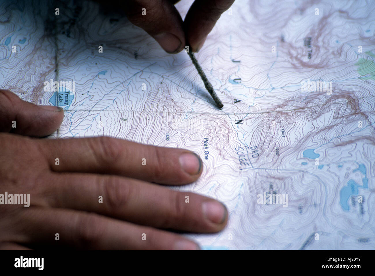 Hiker reading map Stock Photo - Alamy