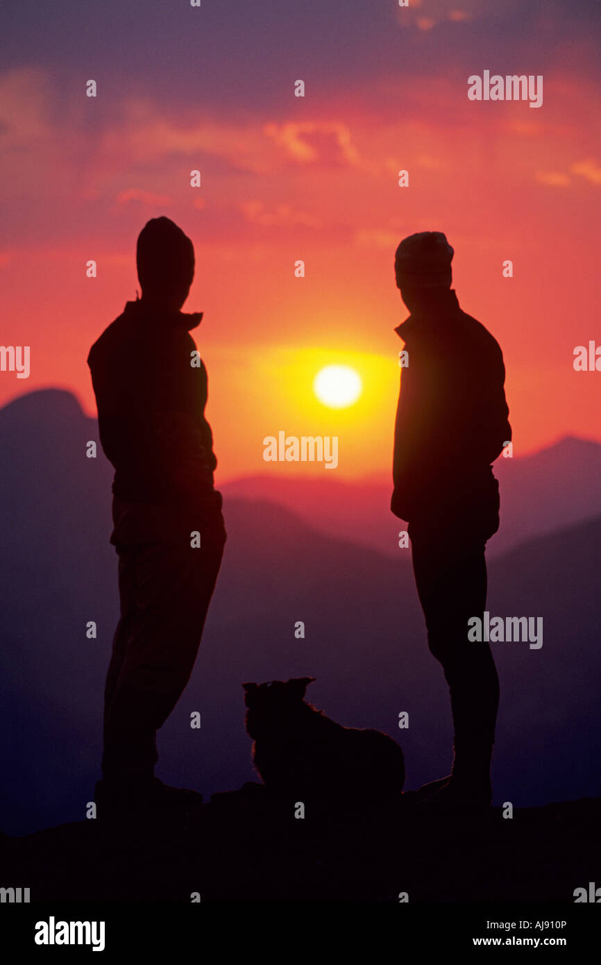 Two men watching sunset Stock Photo - Alamy