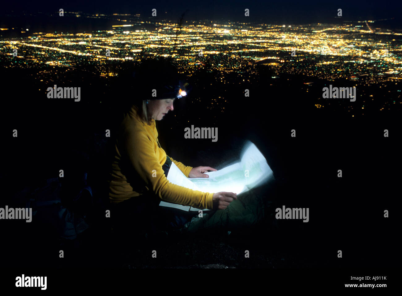 Woman reading map by headlamp Stock Photo - Alamy