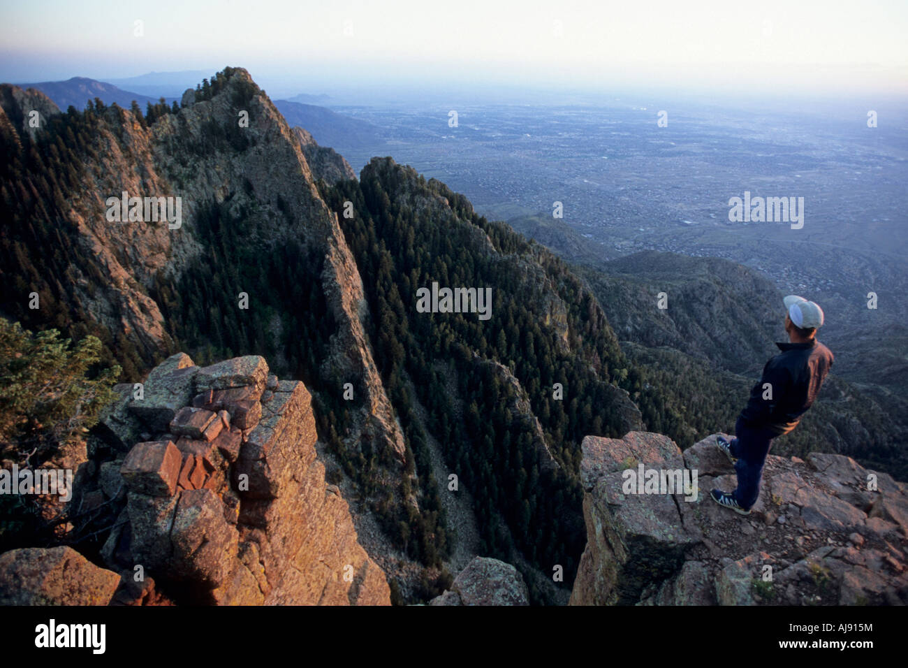 Man standing on rocky ridge Stock Photo - Alamy